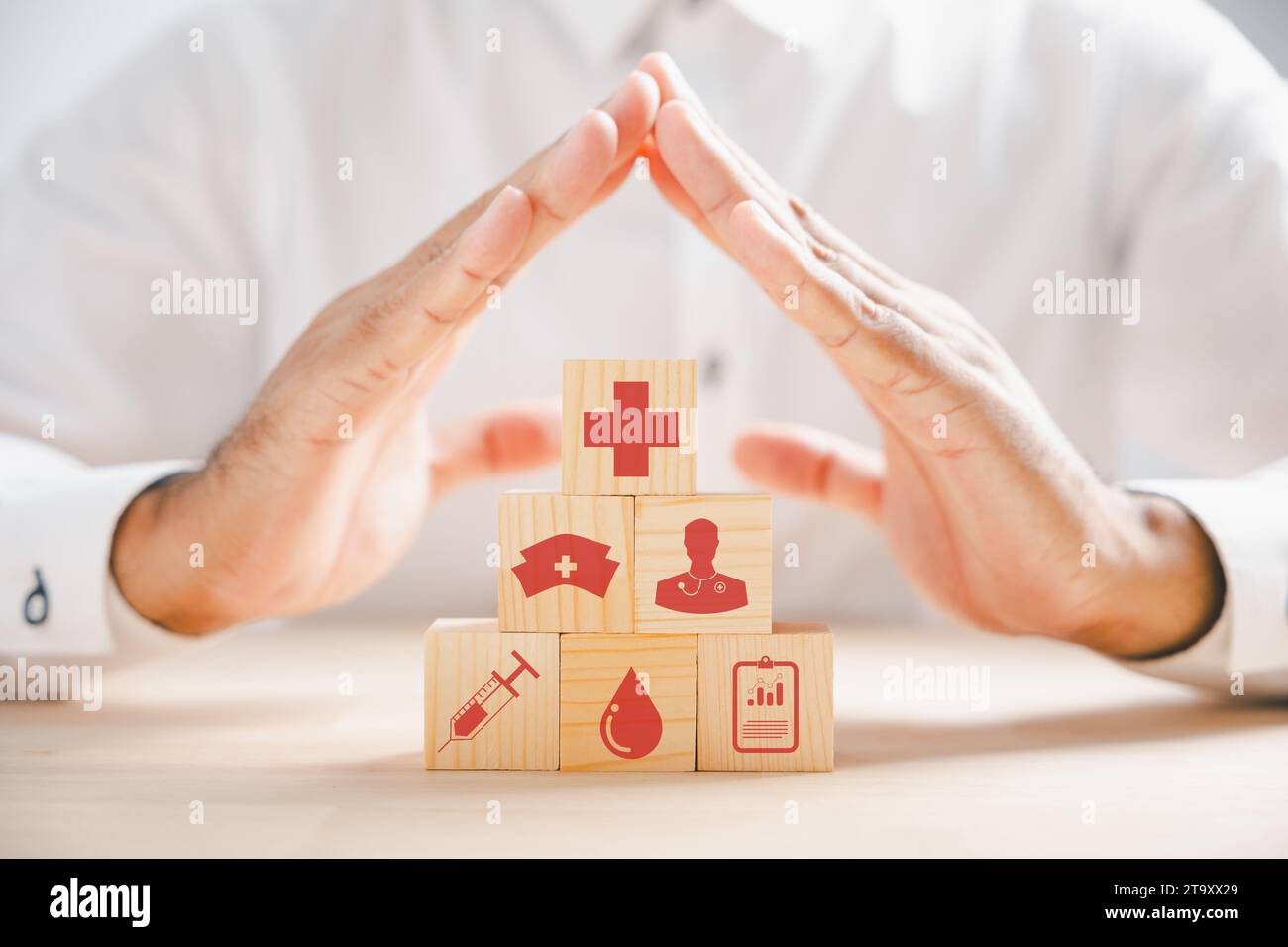 Wooden cube block with health icons and a doctor hand showing ...