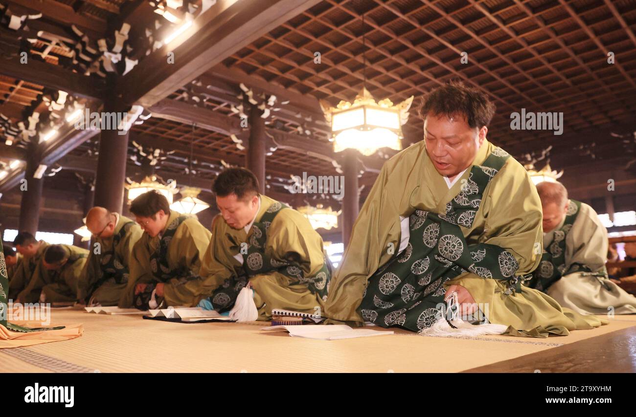 Japanese monks moving their bodies in all directions chant a Buddhist ...
