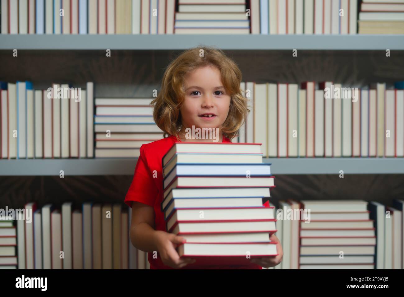 Intellectual child, clever pupil. Little student boy reading book at ...