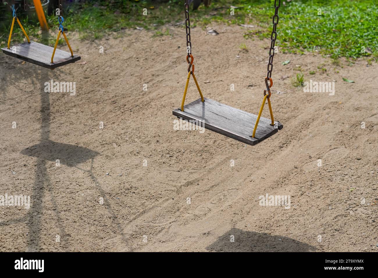 Empty chain old swing in playground Stock Photo - Alamy