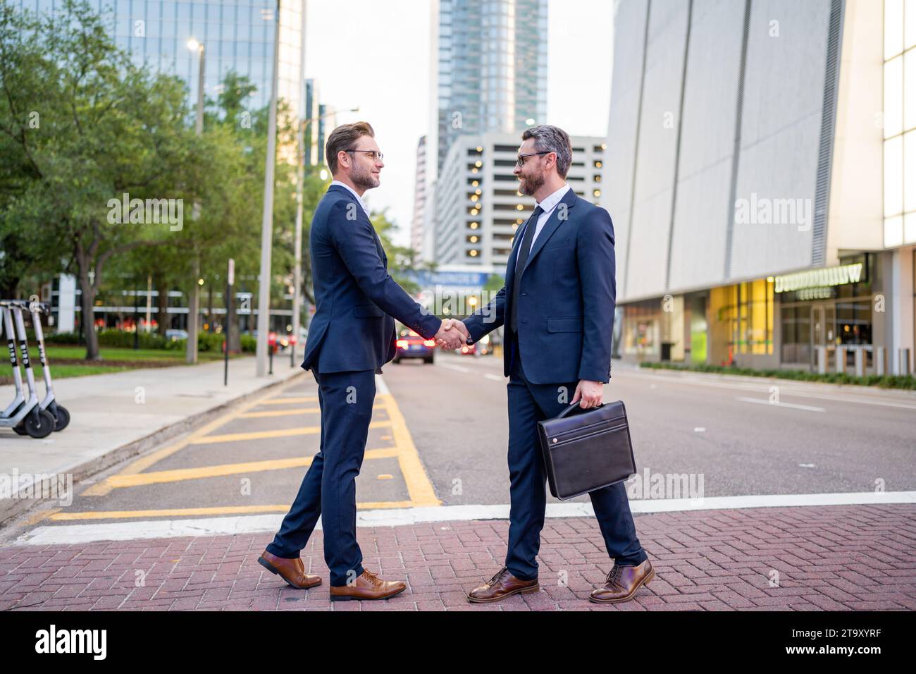 Business man shaking hands. Two businessmen handshake outdoor ...