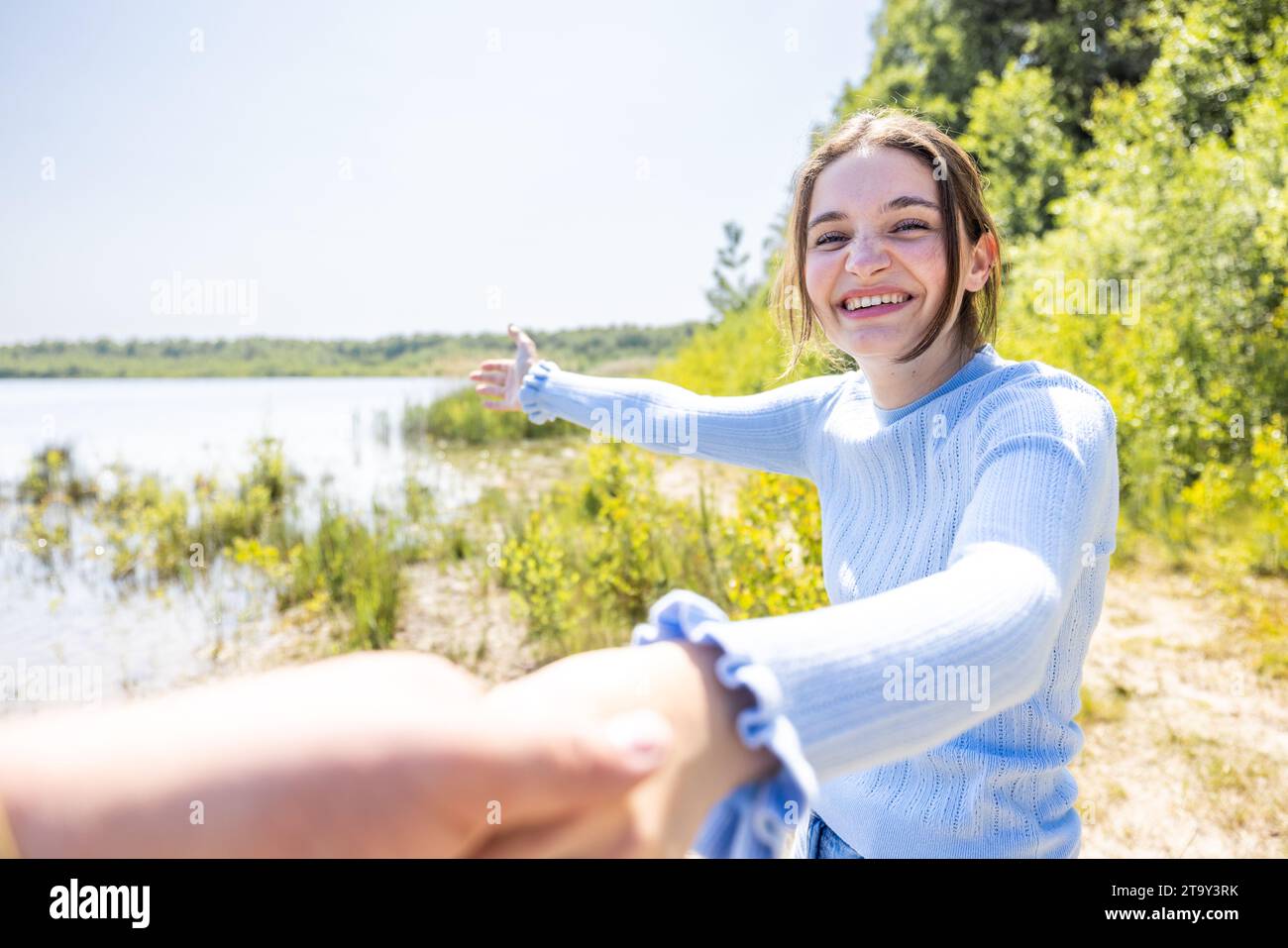 In this image, a cheerful young woman with a bright smile is seen ...