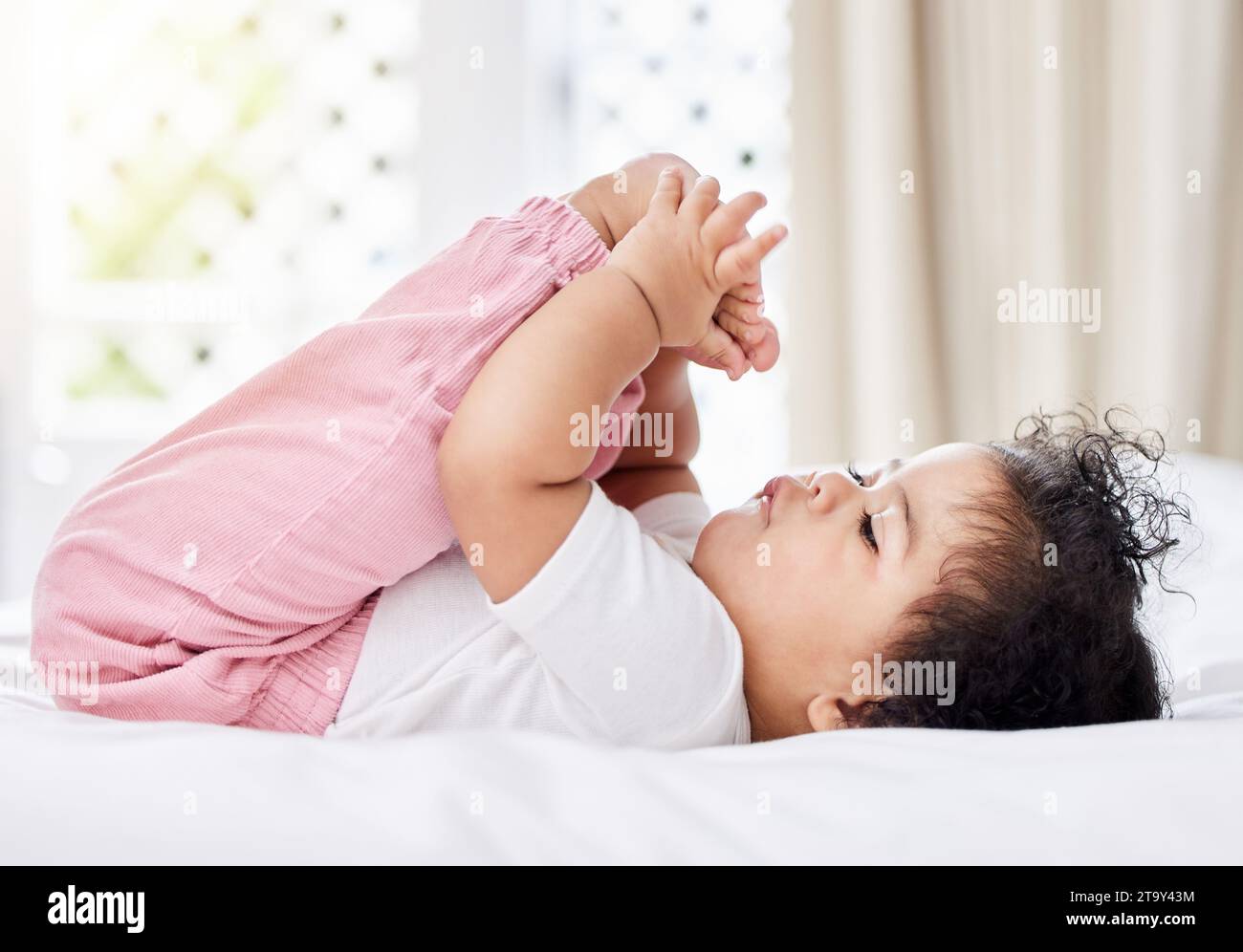 Baby, feet and hands with curiosity in bedroom for motor skills, growth ...