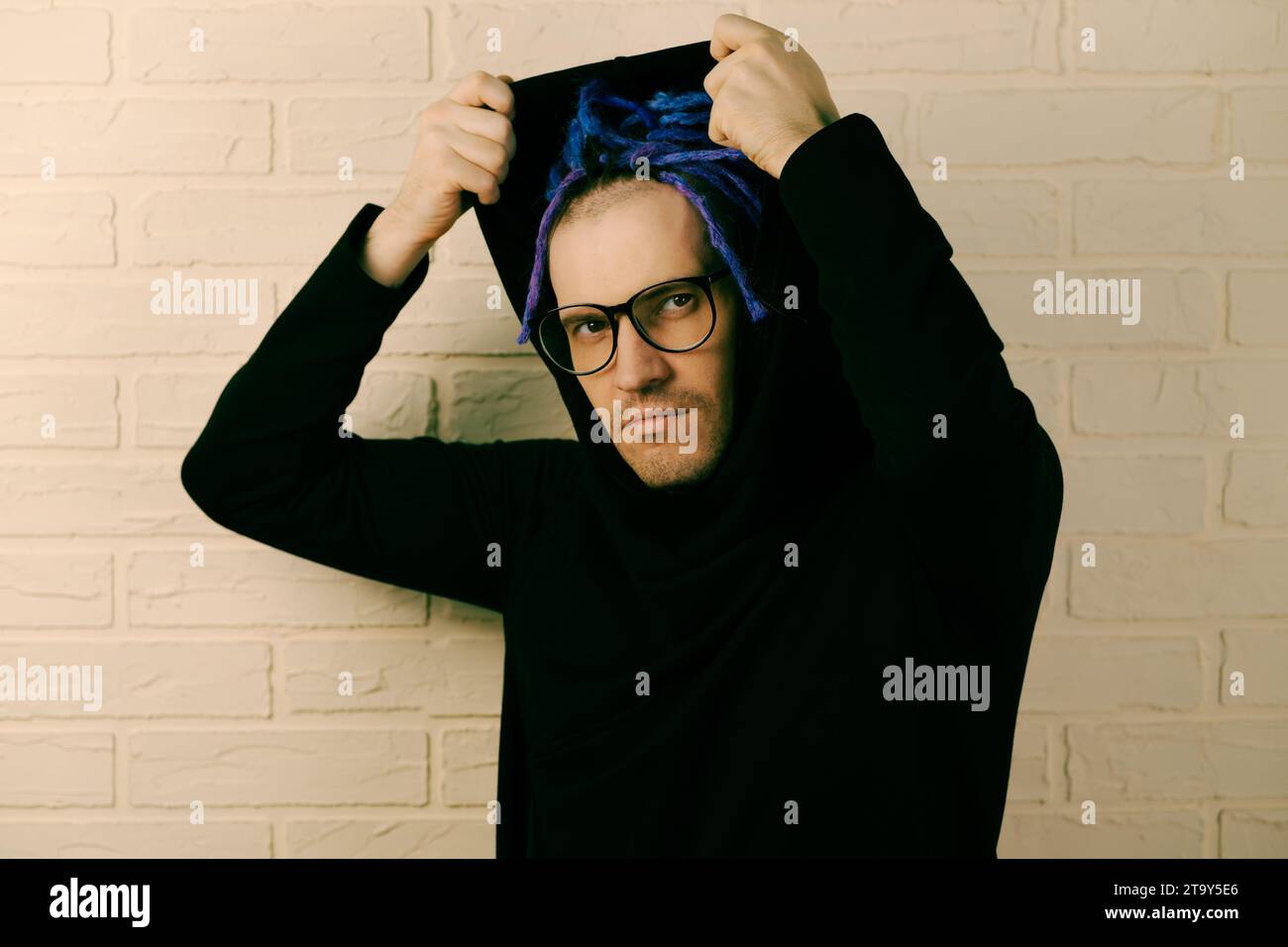 The Vibrant Man with Striking Purple Dreadlocks and Unique Style, puts ...