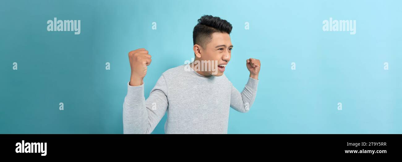 very happy man and excited doing winner gesture with arms raised Stock ...