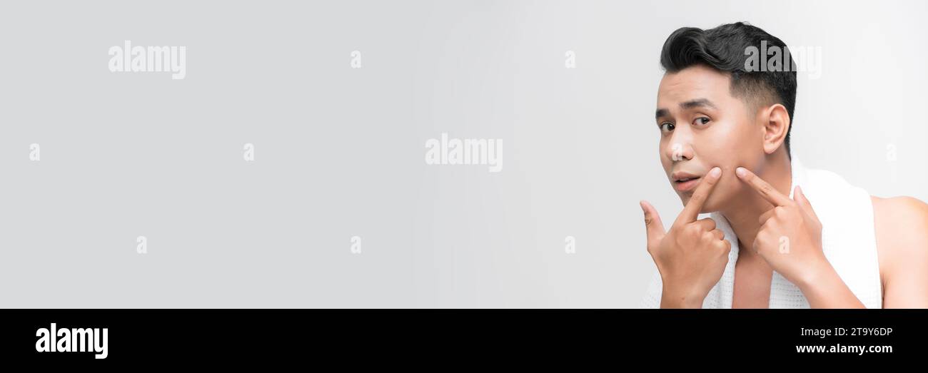 Handsome man touching his face. Squeezing pimple Stock Photo - Alamy