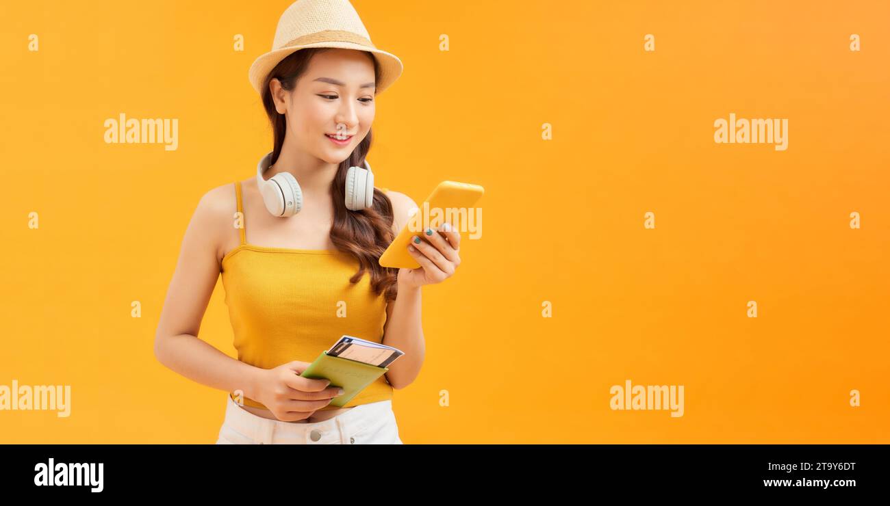 Young woman wear summer clothes hold passport ticket use mobile cell ...