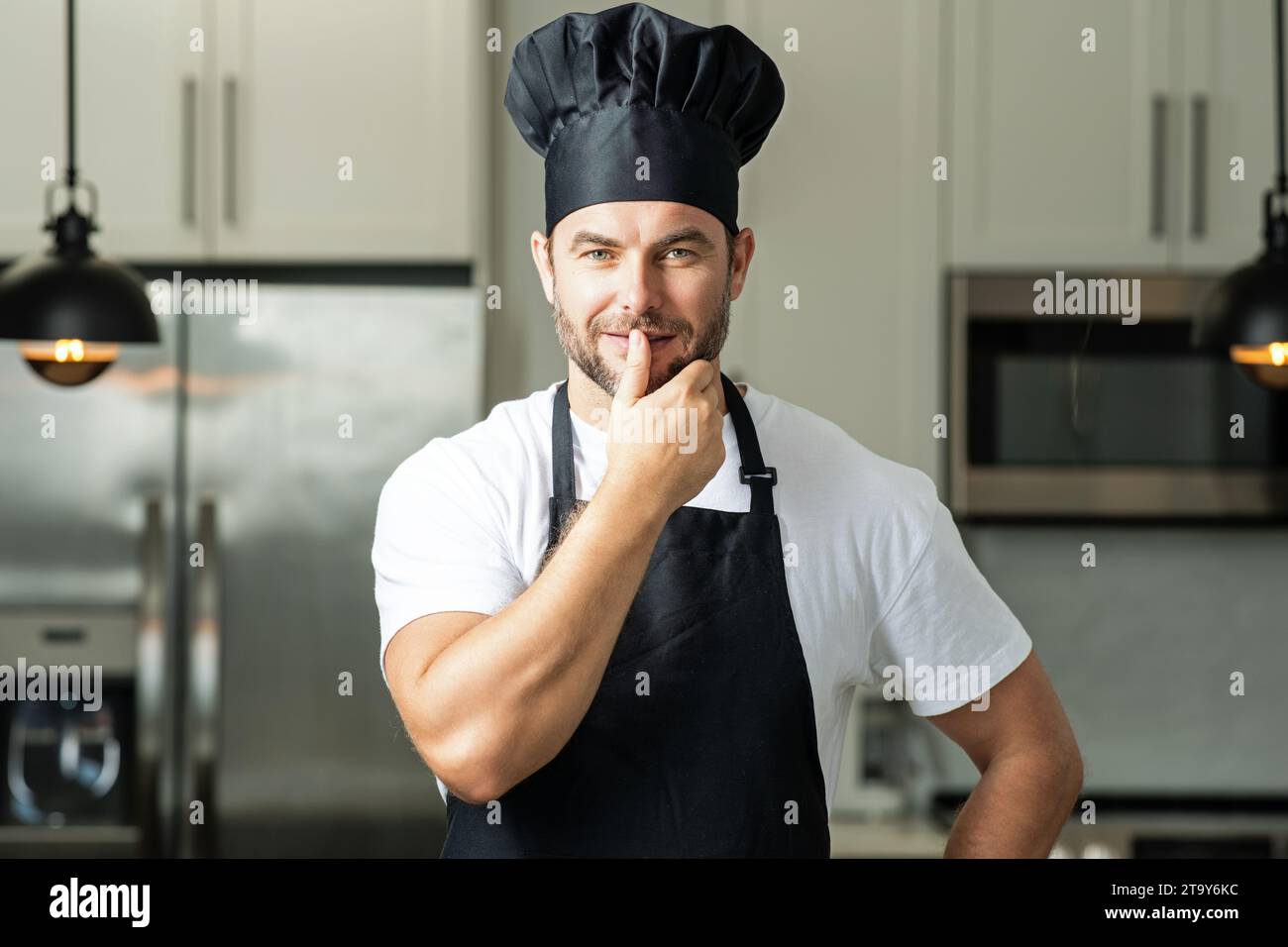 Chef on kitchen. Professional chef man in uniform on kitchen. Bearded ...