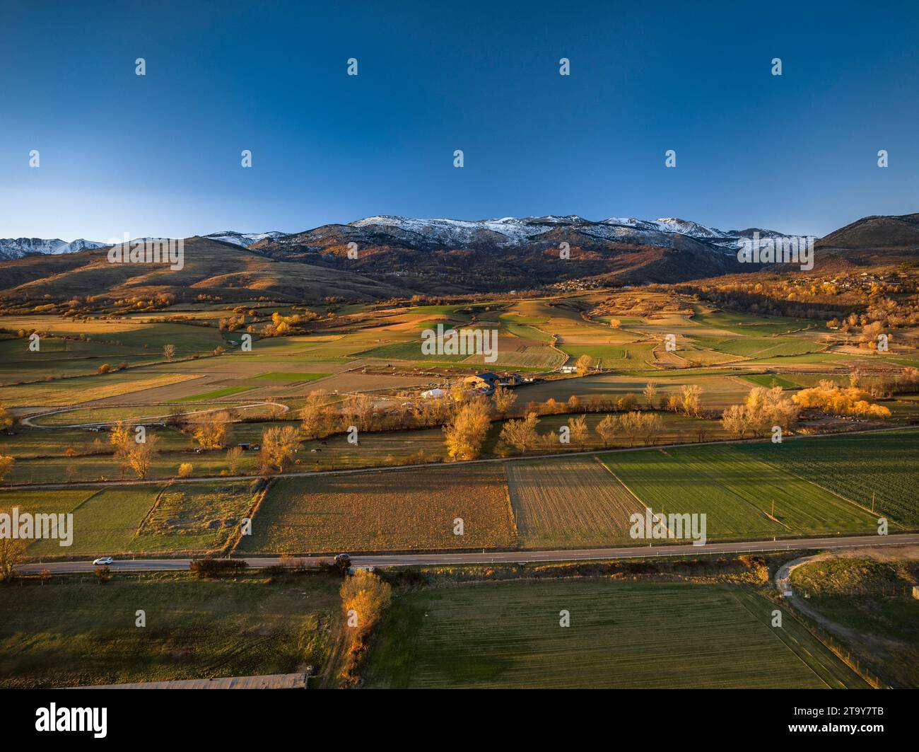 Aerial view of Llívia and its rural surroundings on an autumn sunset ...