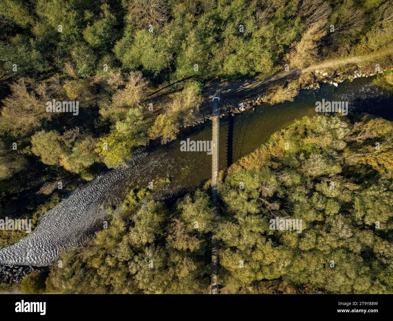 Aerial view of the simple suspension bridge walkway over the Segre ...