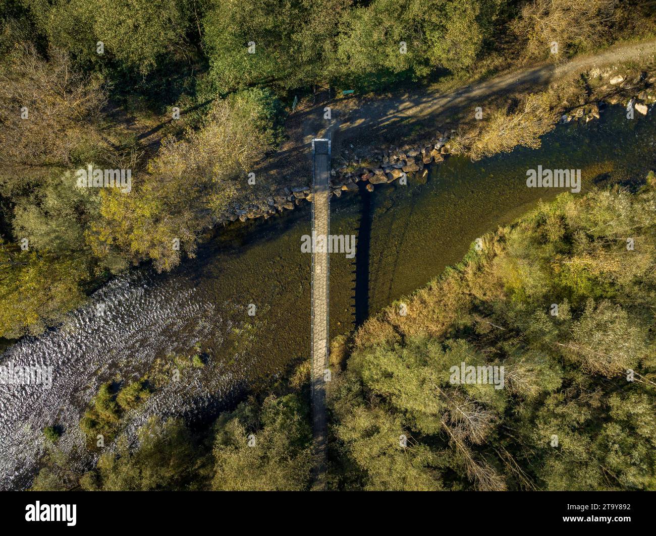 Aerial view of the simple suspension bridge walkway over the Segre ...