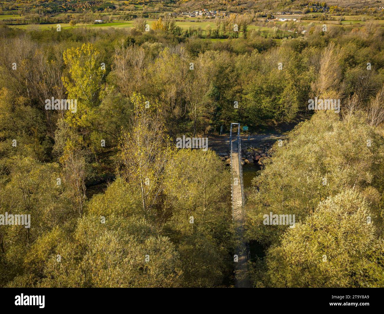 Aerial view of the simple suspension bridge walkway over the Segre ...