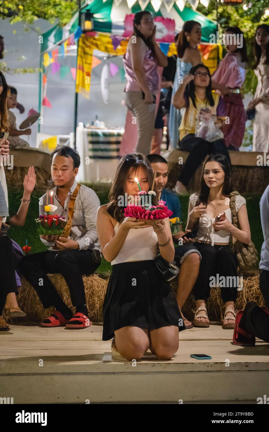 Thai and foreigners are seen with their krathong, on the bank of the ...