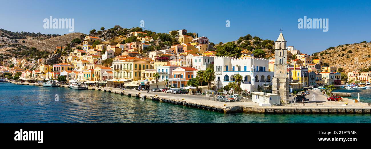View of the beautiful greek island of Symi (Simi) with colourful houses ...