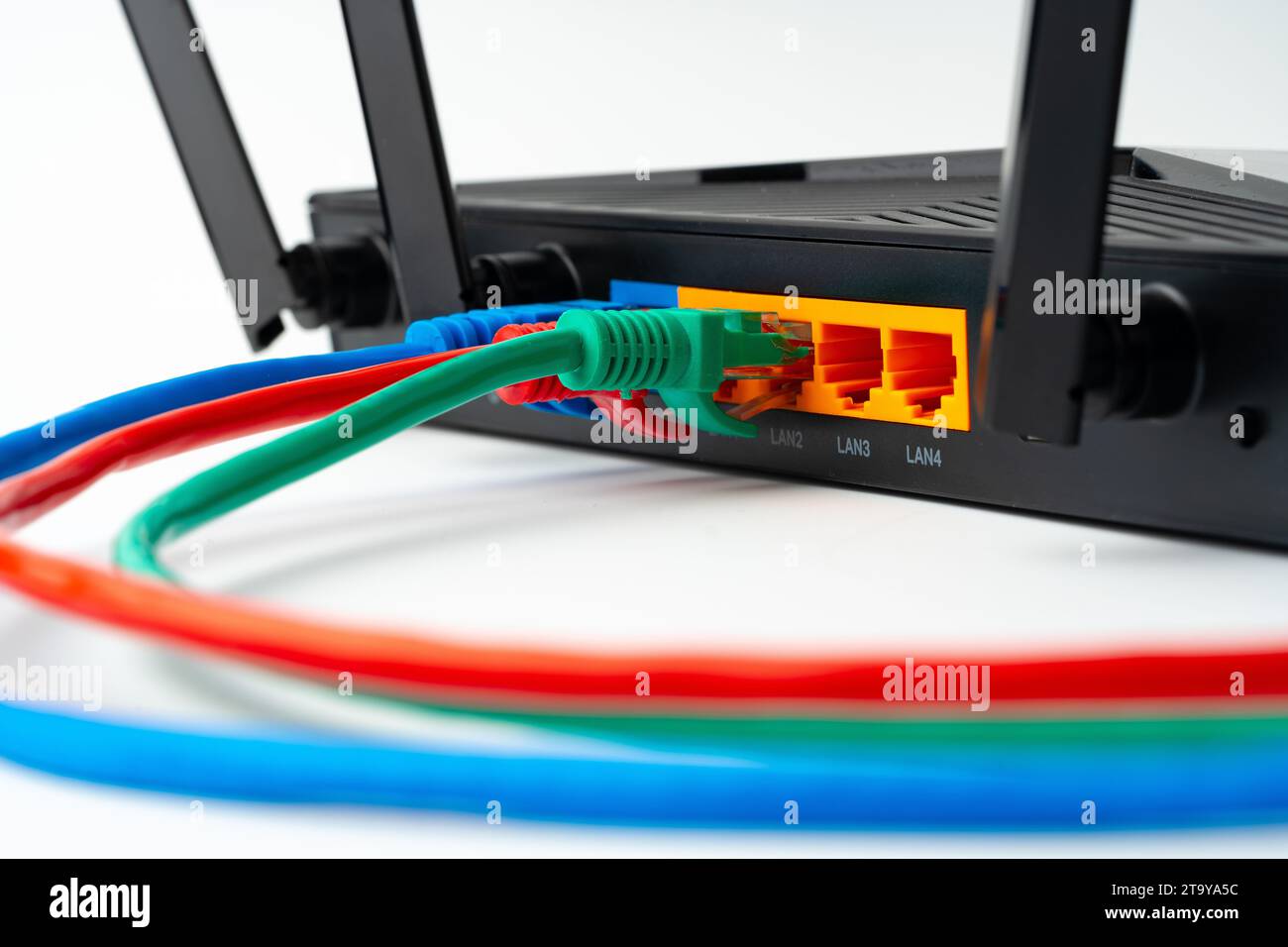 Modern router with cables plugged in close up Stock Photo - Alamy