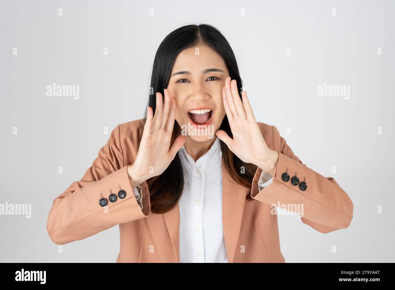 Pretty Asian business female woman with open mouth raising hand ...