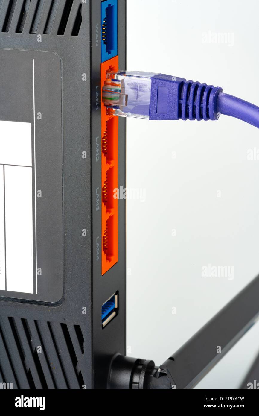 Modern router with cables plugged in close up Stock Photo - Alamy