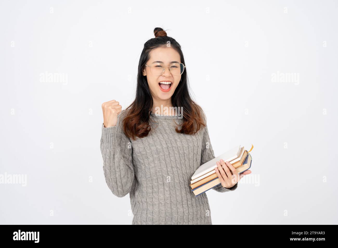 Adorable and cheerful Asian college student showing happy pose ...
