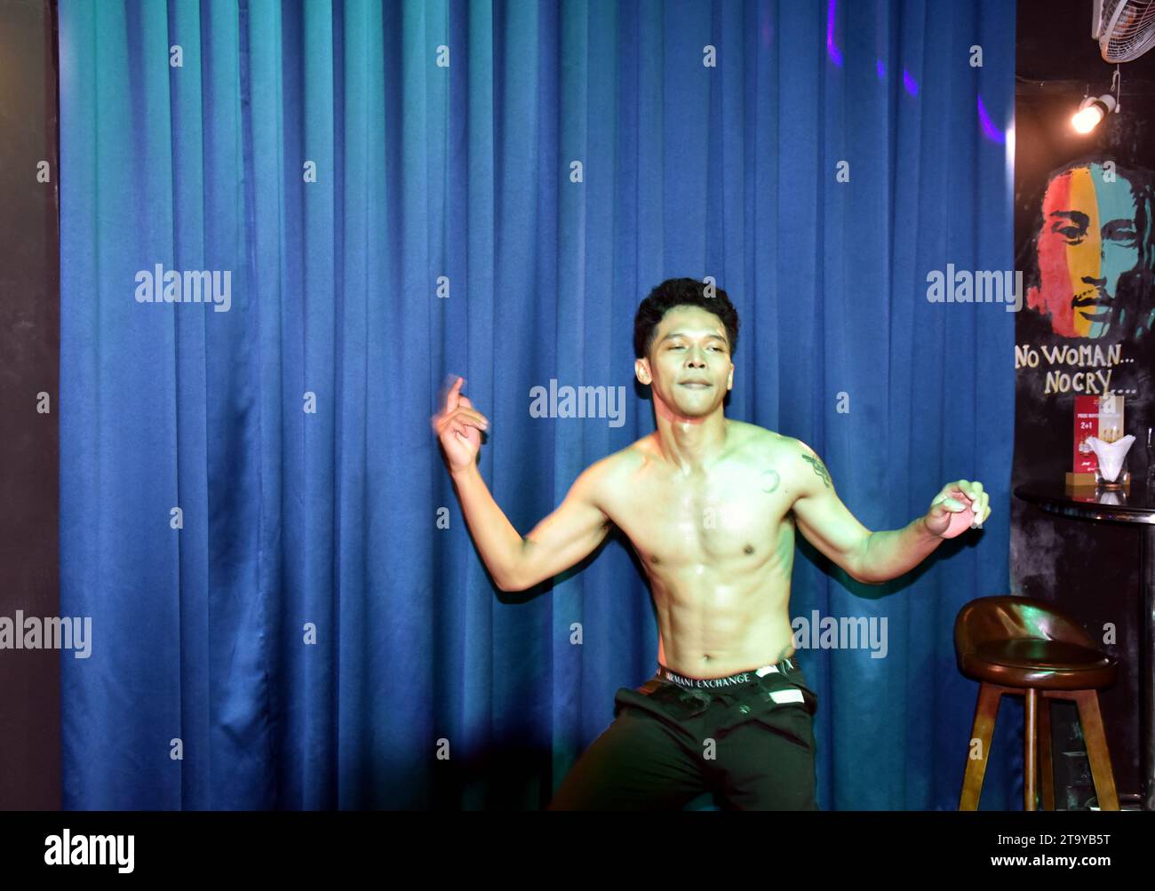 A handsome, young, energetic, impressive, muscled, shirtless dancer ...