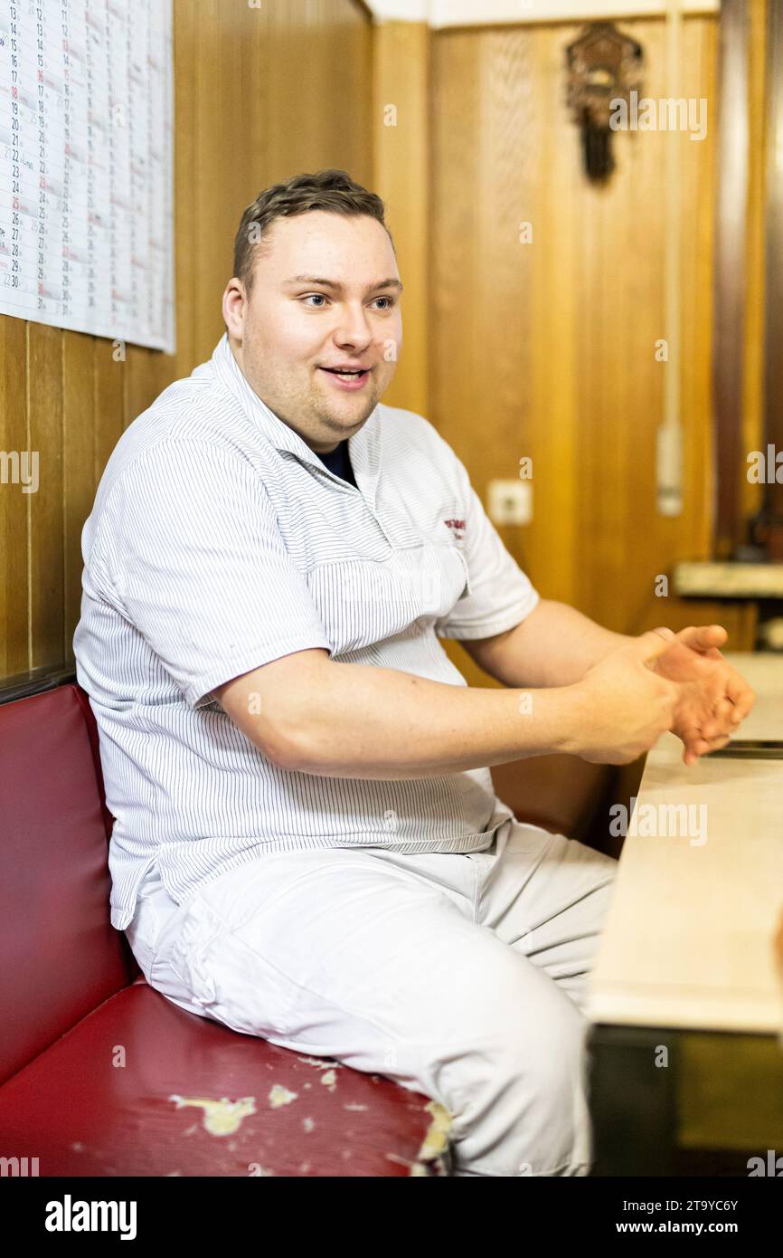 Wolsdorf, Germany. 22nd Nov, 2023. Alexander Richter, butcher, sits in ...