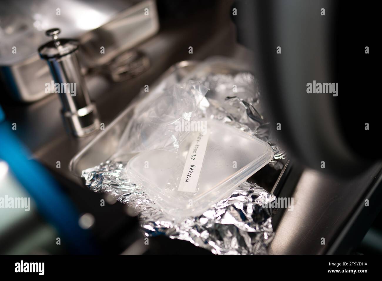 Scientists at the Natural History Museum in London, study a sample of ...