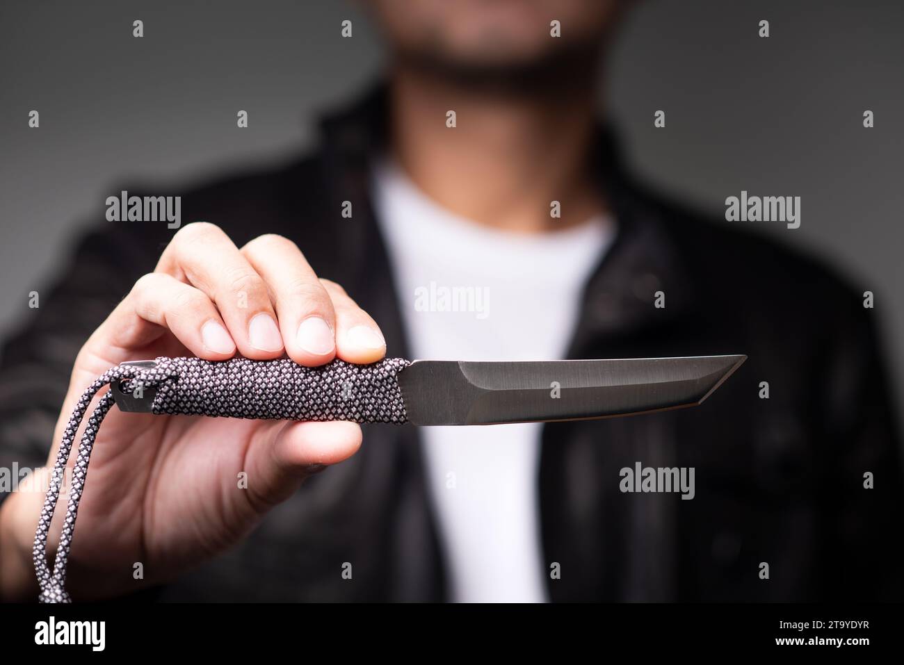 The man holding a pocketknife with Tanto blade in hand Stock Photo - Alamy