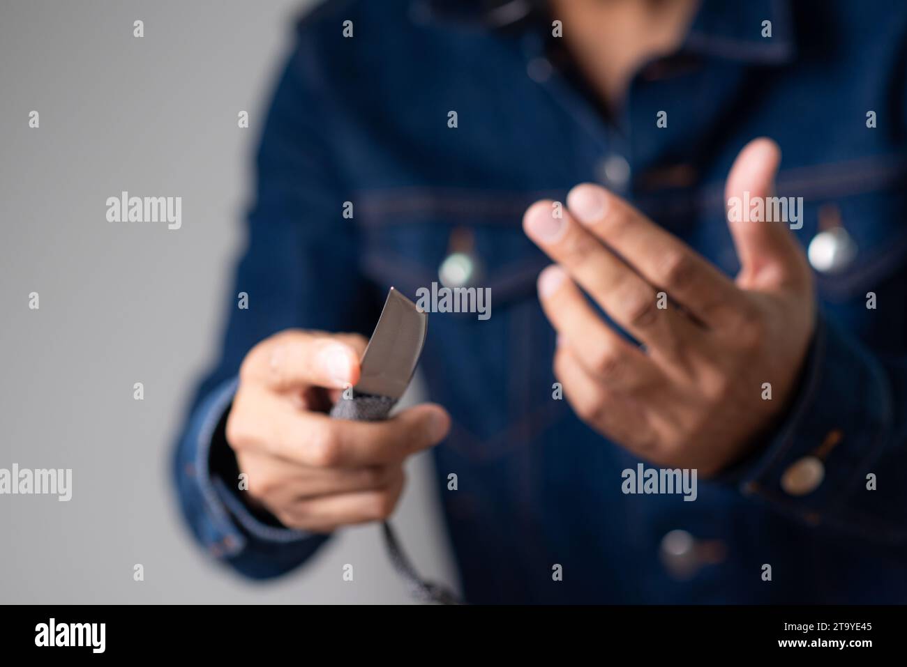 The man holding a pocketknife with Tanto blade in hand Stock Photo - Alamy