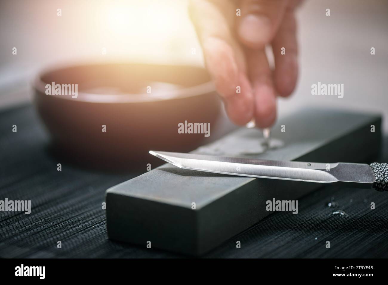 Knife sharpening with whetstone or grindstone Stock Photo - Alamy