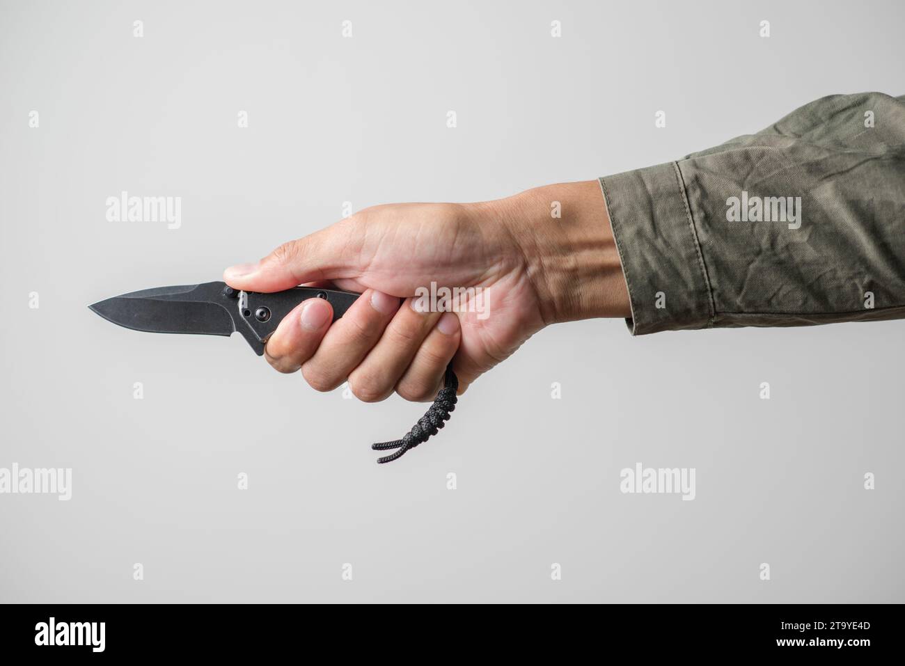 The man holding a pocketknife in hand Stock Photo - Alamy