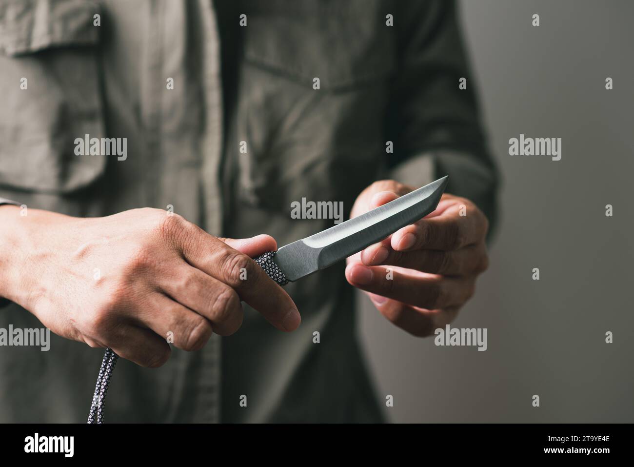 The man holding a pocketknife with Tanto blade in hand Stock Photo - Alamy