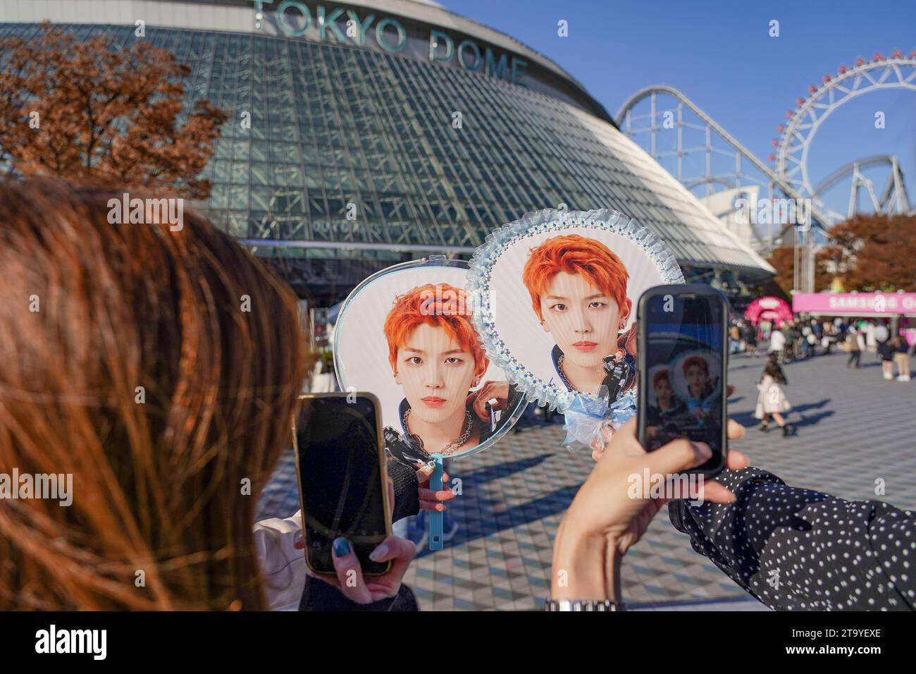 Fans take photos of images of INI member Hiromu Takatsuka ahead of the red carpet at the 2023 ...