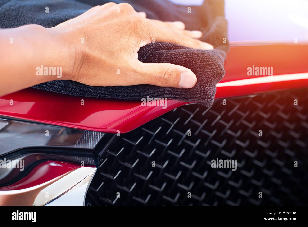 Cleaning the red car with microfiber cloth. Car detailing concept Stock ...
