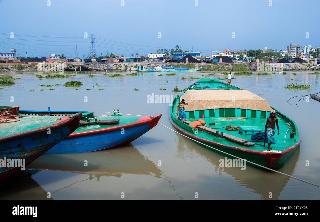 Traditional cargo boat station beside the riverbank. A picturesque ...