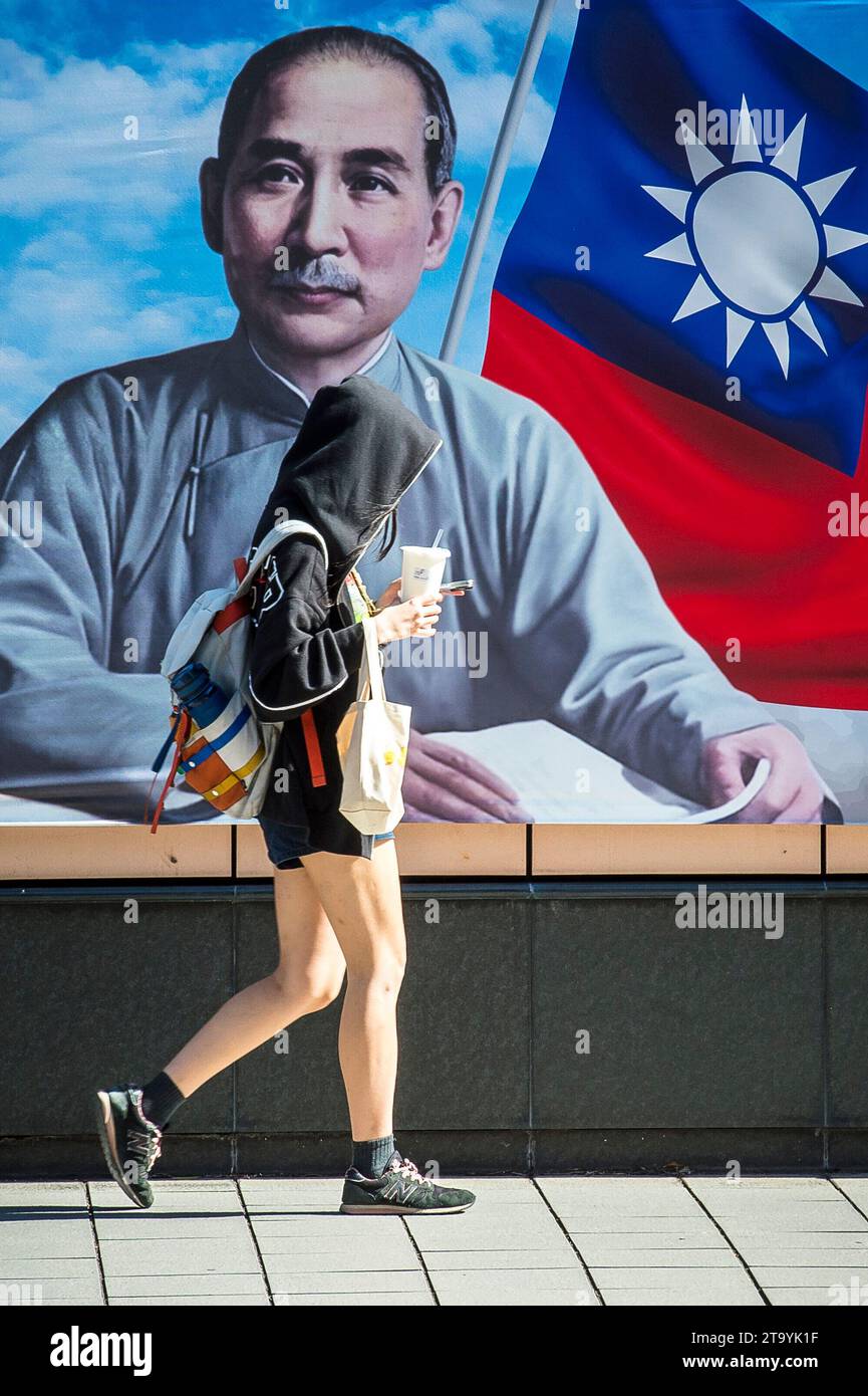 Passersby walk by an image of Sun Yat-sen - Chinese politician and ...