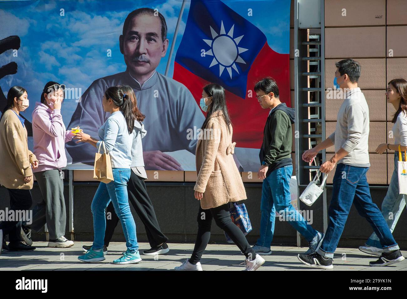 Passersby walk by an image of Sun Yat-sen - Chinese politician and ...