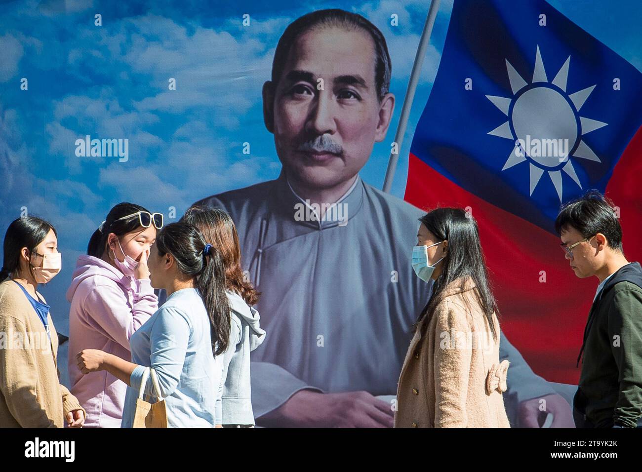 Passersby walk by an image of Sun Yat-sen - Chinese politician and ...