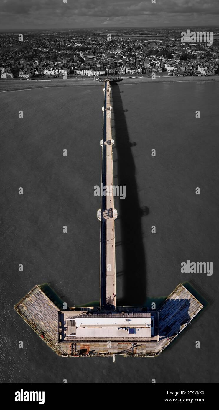 A vertical aerial view of the Deal Pier in Kent on a grayscale ...