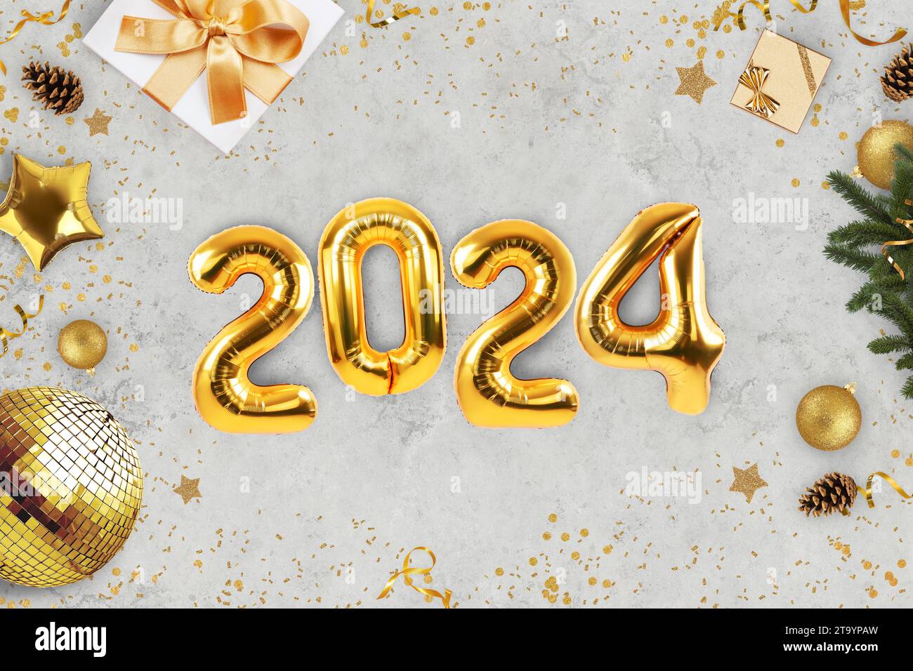 New Year golden balls 2024 luxury on a gray concrete table with gifts ...