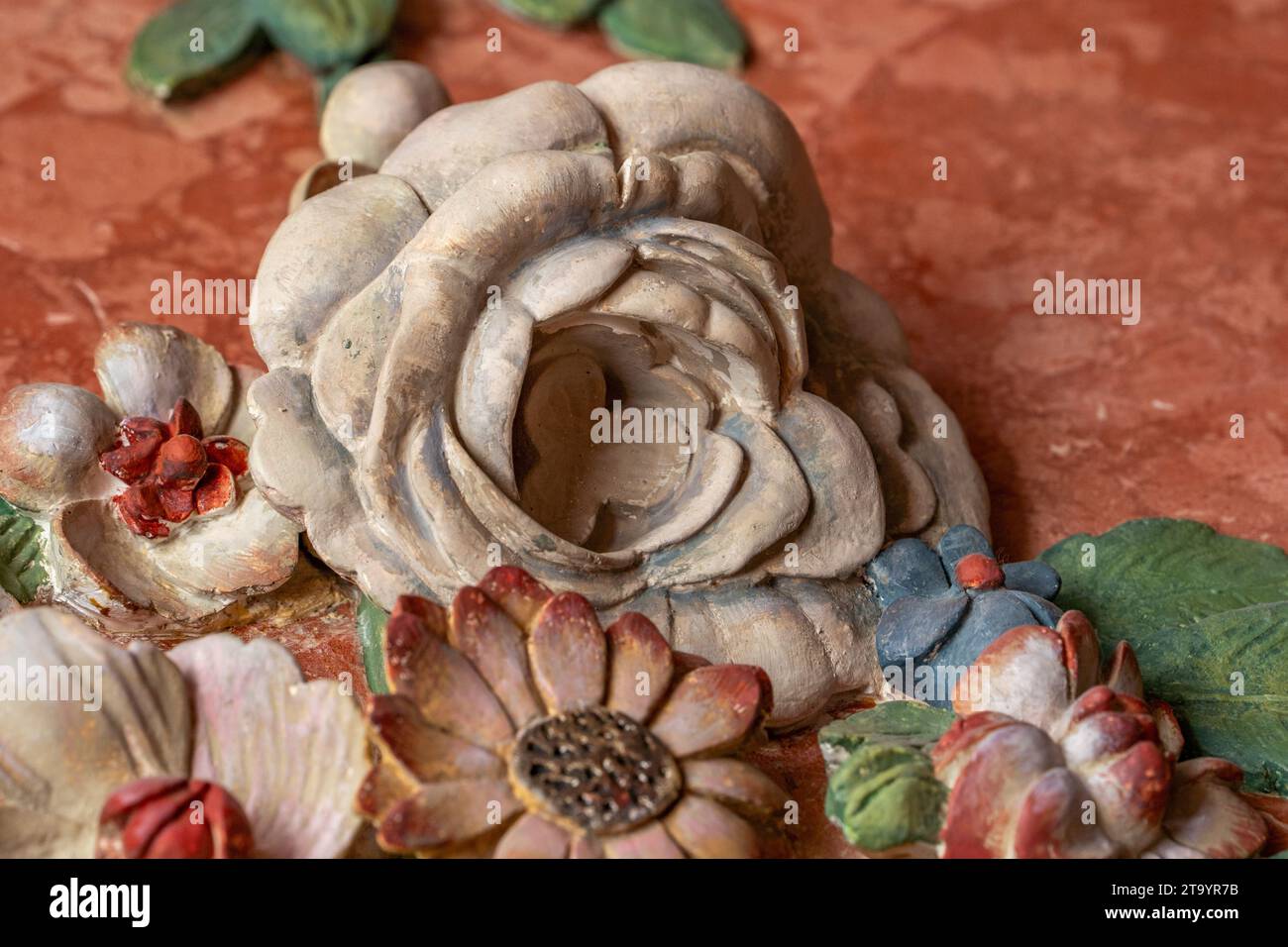 A white stone rose on a wall Stock Photo - Alamy