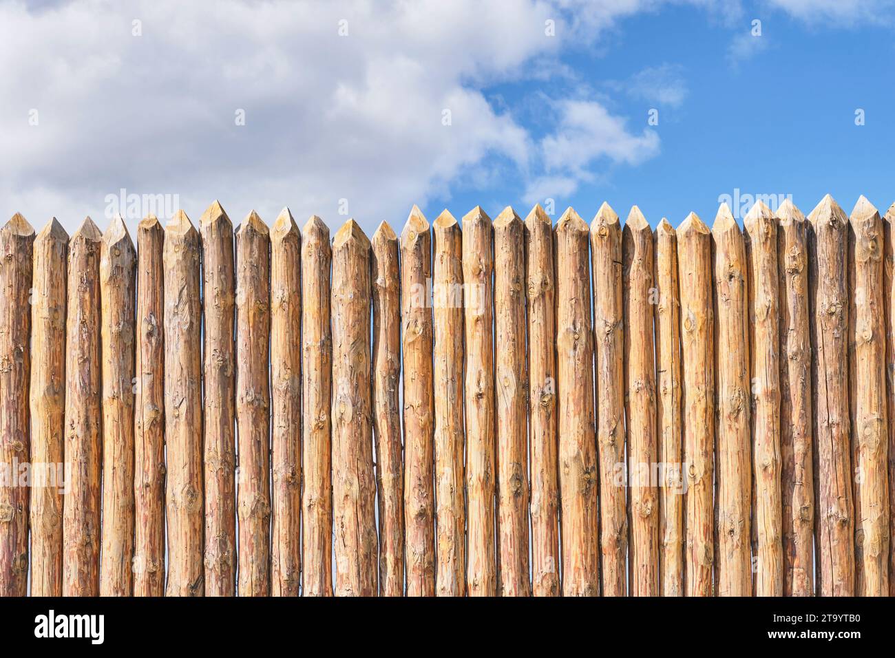 Palisade and cloudy sky as abstract rustic or historical background ...