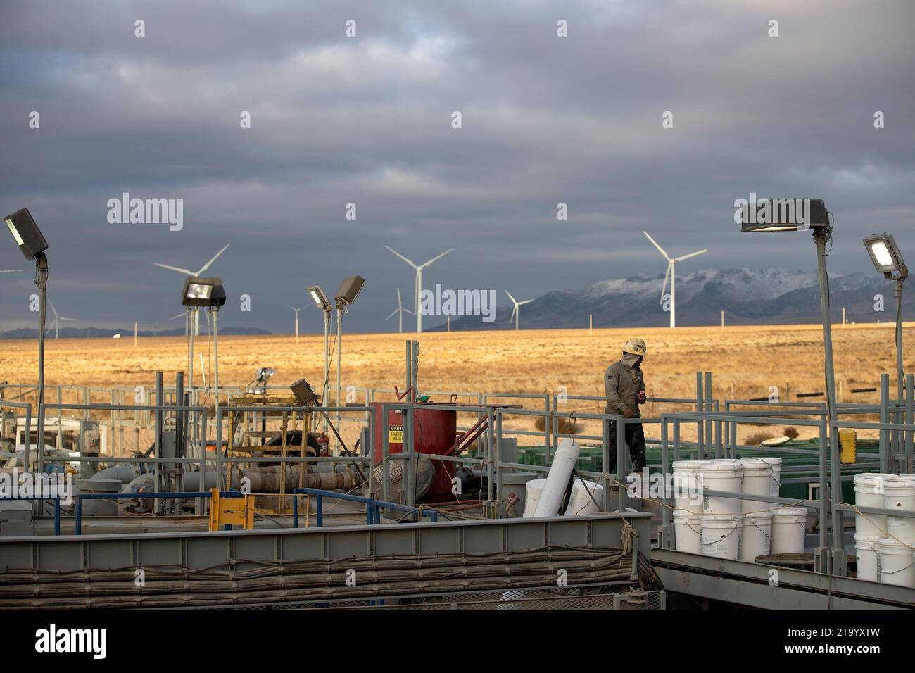 A rig operator walks through a Fervo Energy geothermal drilling site ...