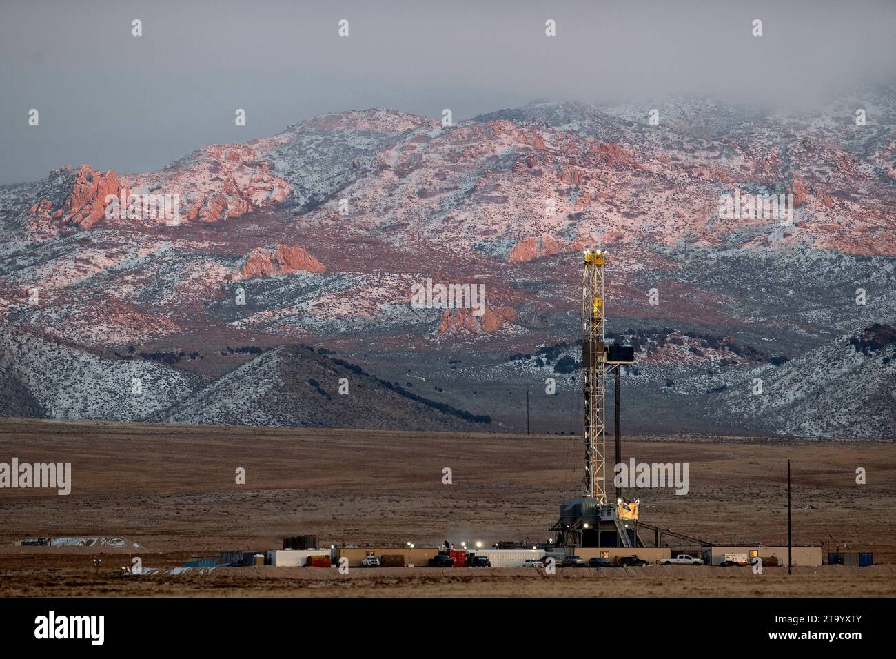 A drill rig stands at a Fervo Energy geothermal site under construction ...