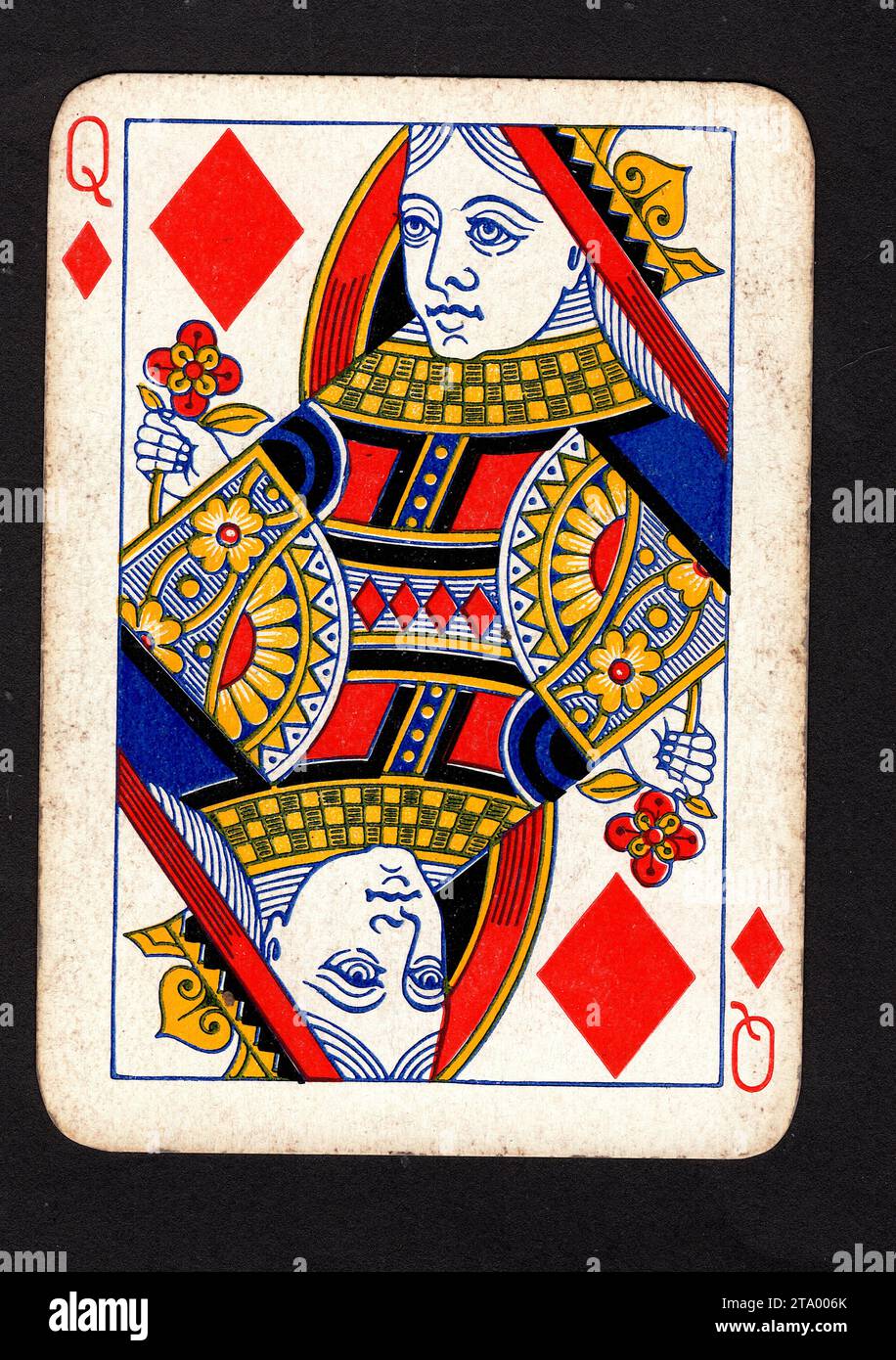 A vintage queen of diamonds playing card isolated on a black background ...