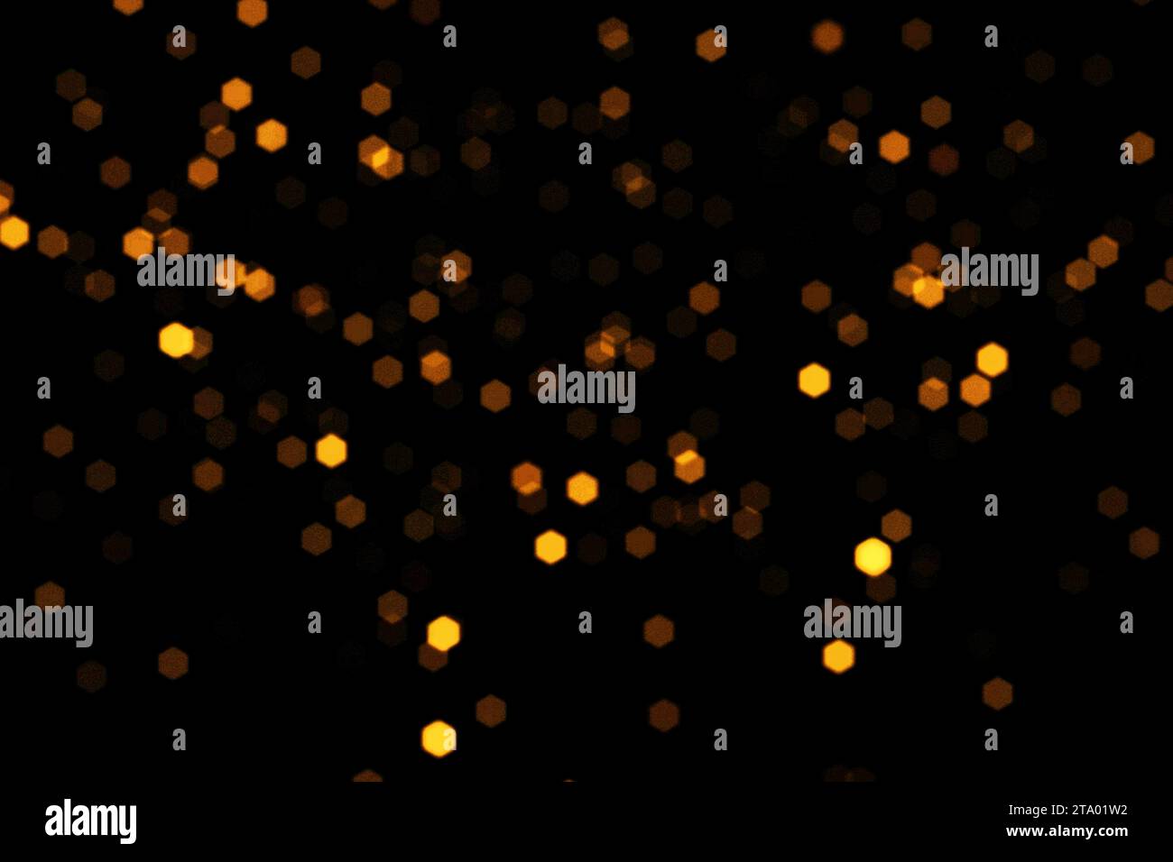 abstract gold glow particles bokeh flowing effect on black background, holiday happy new year ...