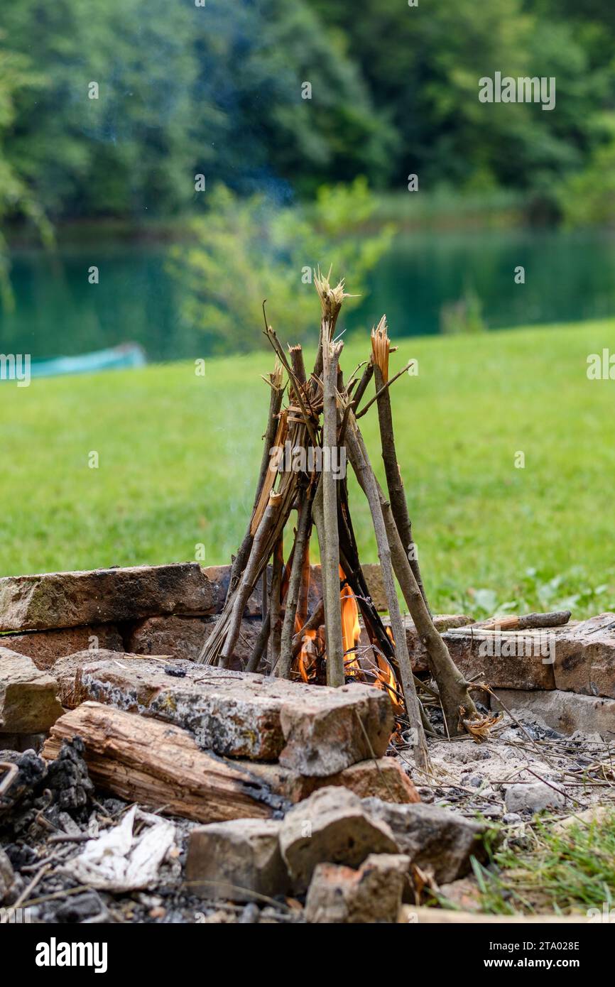 Close-up photo of burning wood in bonfire. Preparing a fire for grill ...