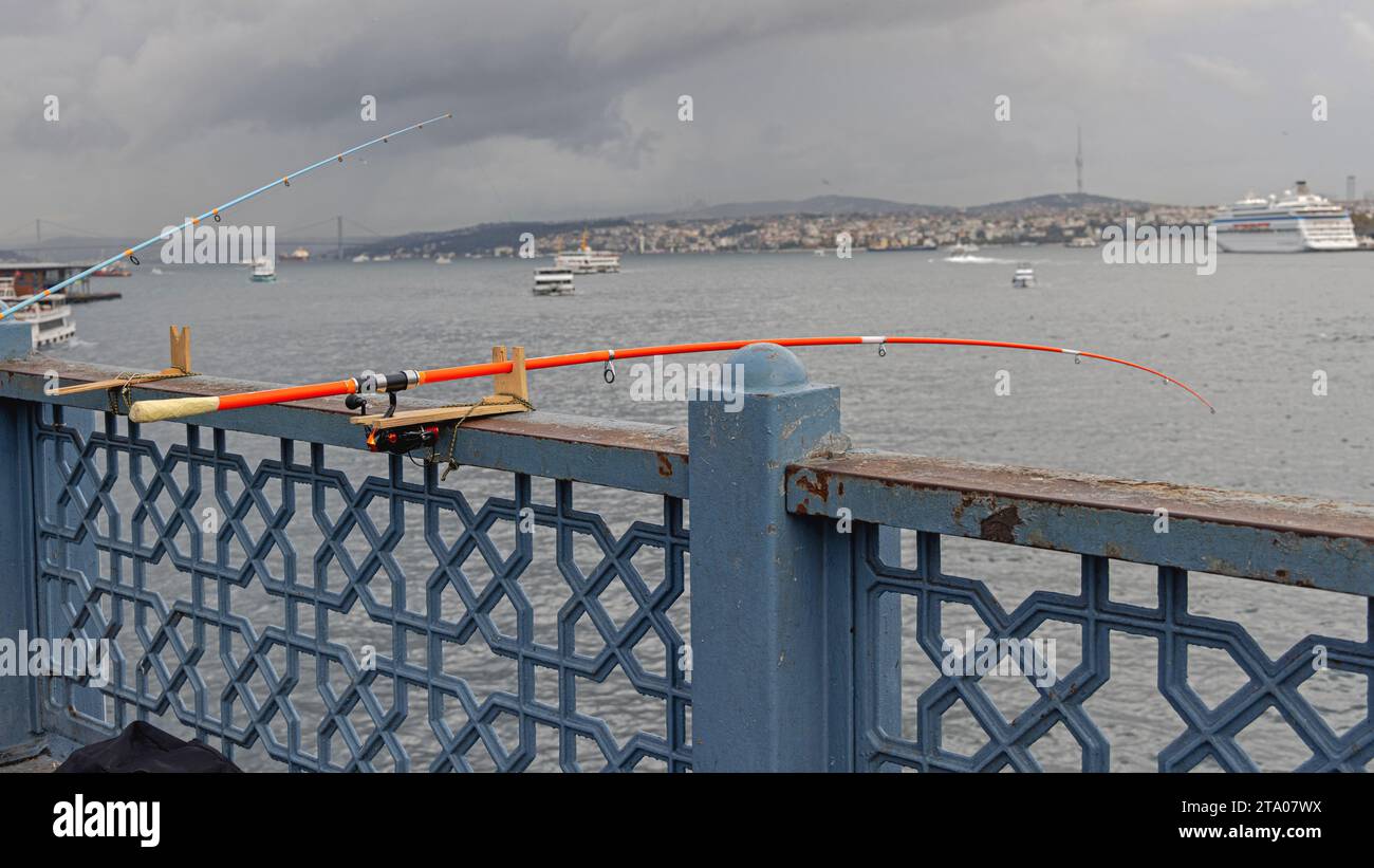 Fluorescent Orange Fishing Rod in Wooden Holder at Bridge Istanbul ...