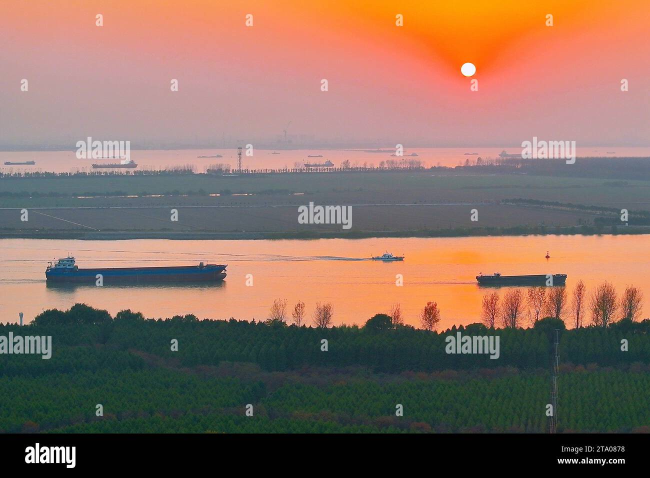 RUGAO, CHINA - NOVEMBER 28, 2023 - Transport ships travel under the ...