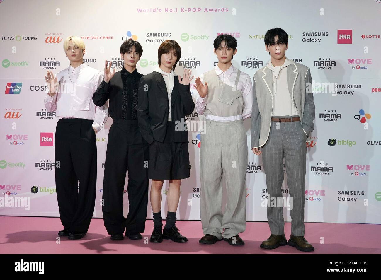 Members of TOMORROW X TOGETHER pose for photos on the red carpet of the 2023 MAMA Awards at ...
