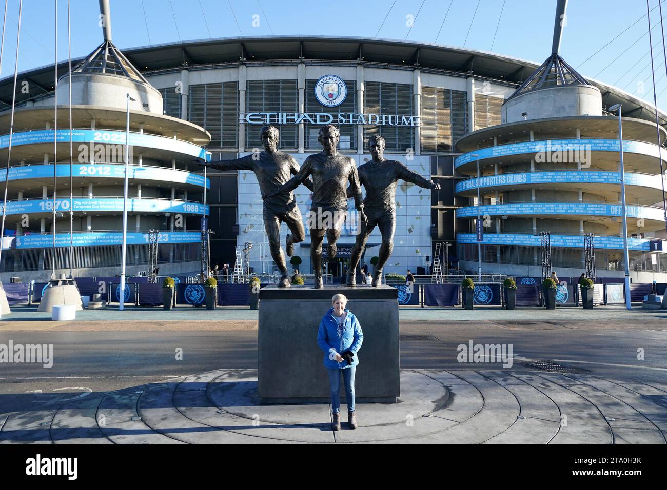 A fan poses in front of the new sculpture outside the Etihad Stadium of ...