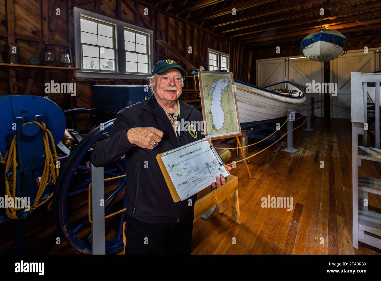 A volunteer at the Sleeping Bear Maritime Museum explains the Lyle Gun ...